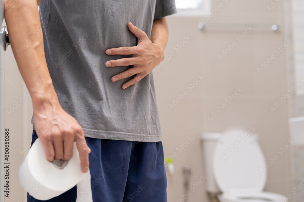 Foto de Constipation and diarrhea in bathroom. Hurt man touch belly ...