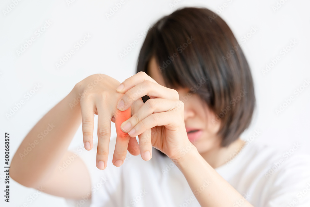 A woman touches her knuckle because of an injury or rheumatoid ...