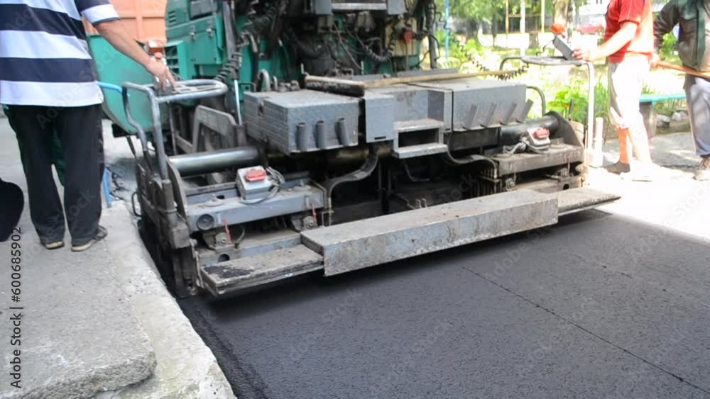 Large asphalt paving machine and people. Paver paving machine. Worker ...