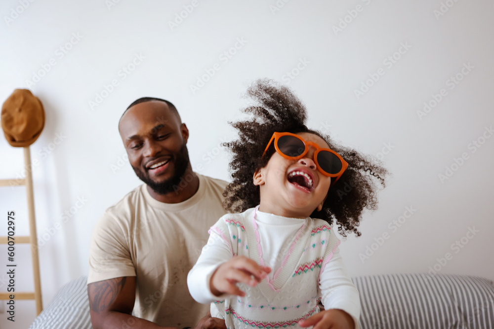 Happy caring African American family young dad father and small cute ...