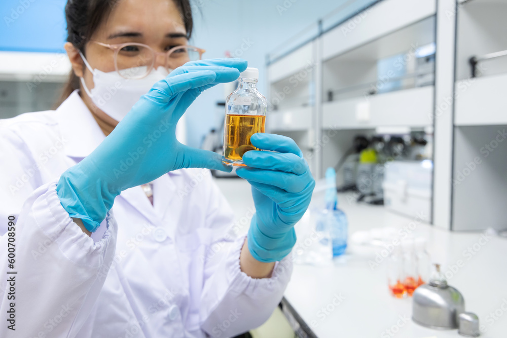 Professional scientist holding solution bottle for test coliform or ...