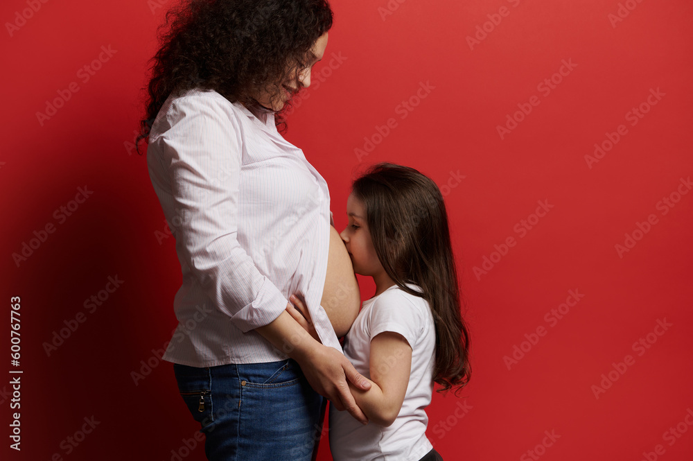 Happy multi ethnic gravid woman standing bare belly with her little ...