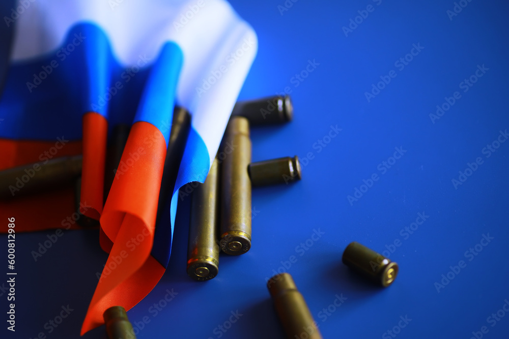 Russian flag and bullet casings on the table. Background concept ...