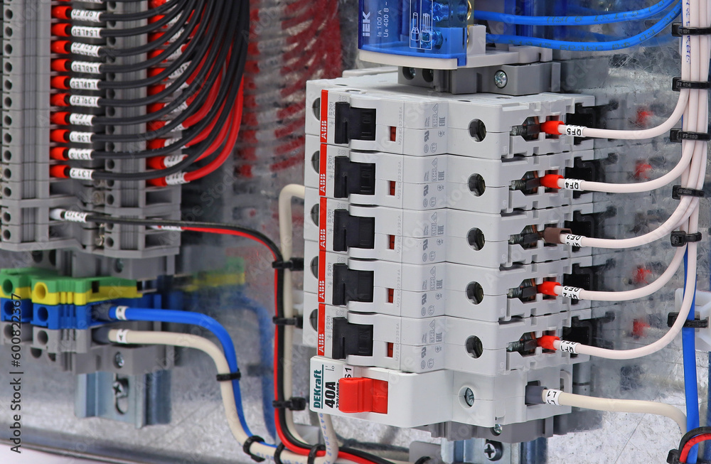 ABB electric circuit breakers installed on a din rail in an electric ...