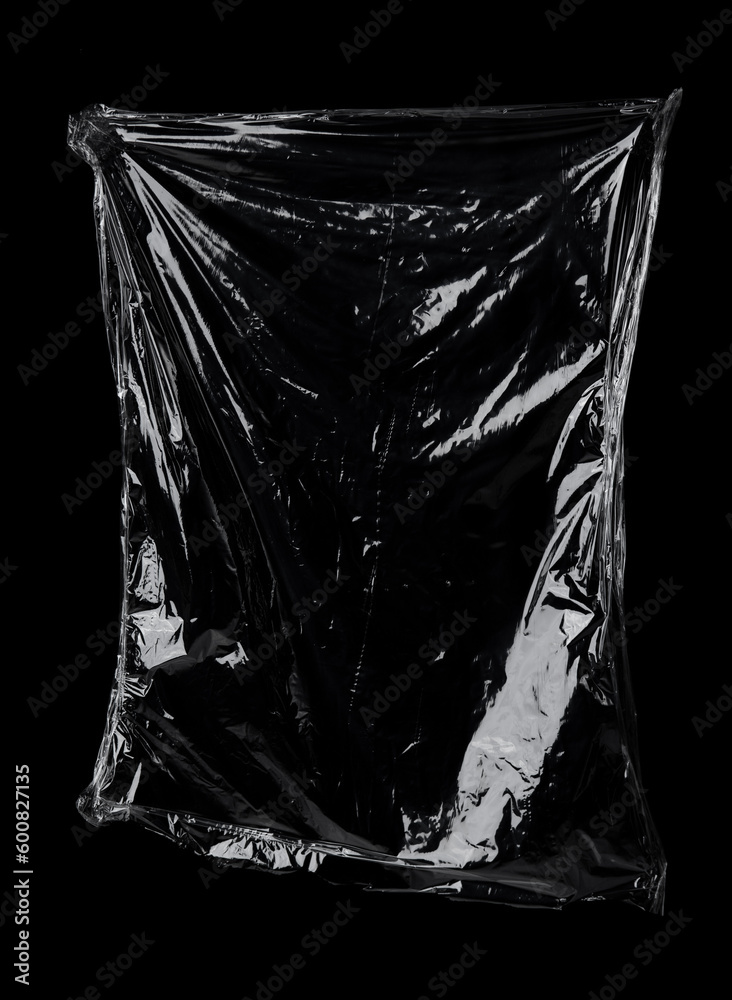 Transparent plastic wrap texture on the black background. Plastic bag ...