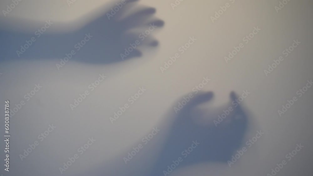 Shadow Blur of a horror man behind frosted glass. Blurred hand, body ...