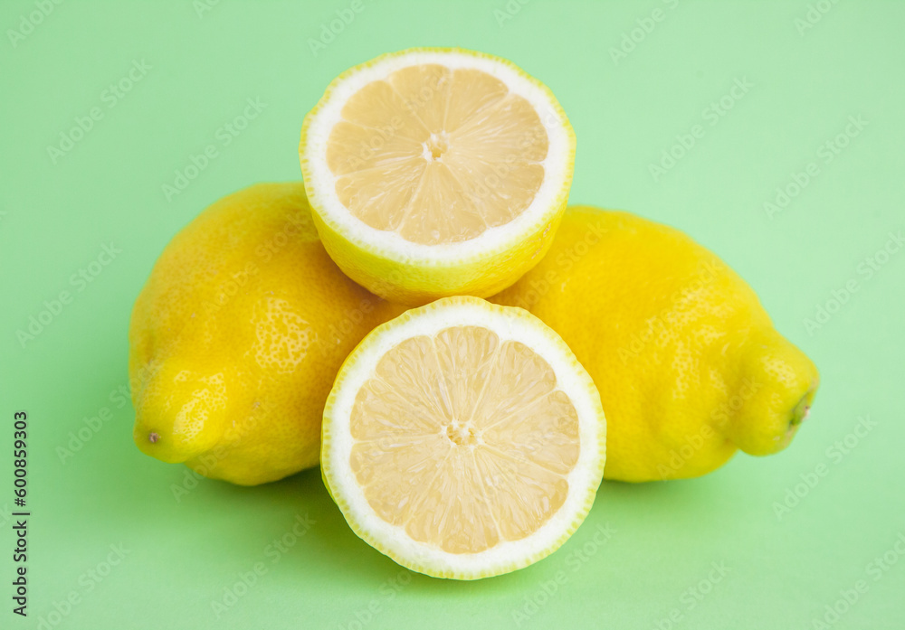 Limones grandes apilados junto a dos mitades de limón para hacer zumo ...