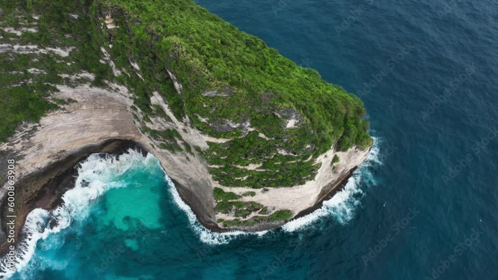 Wild sea washing reef rock cliff. Drone flies around of turquoise ocean ...