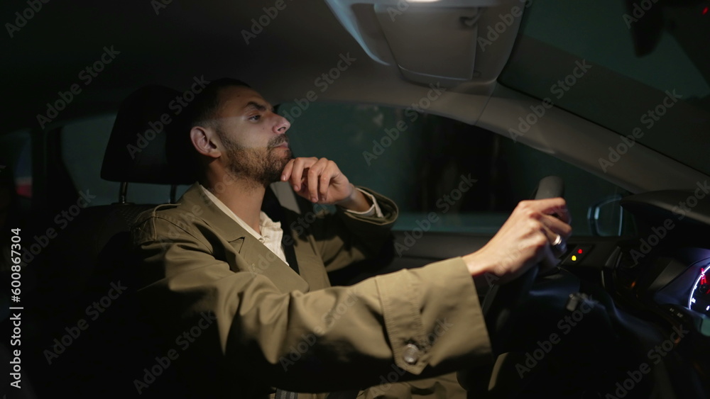 One tense Middle Eastern young man driving on road at night. Male ...