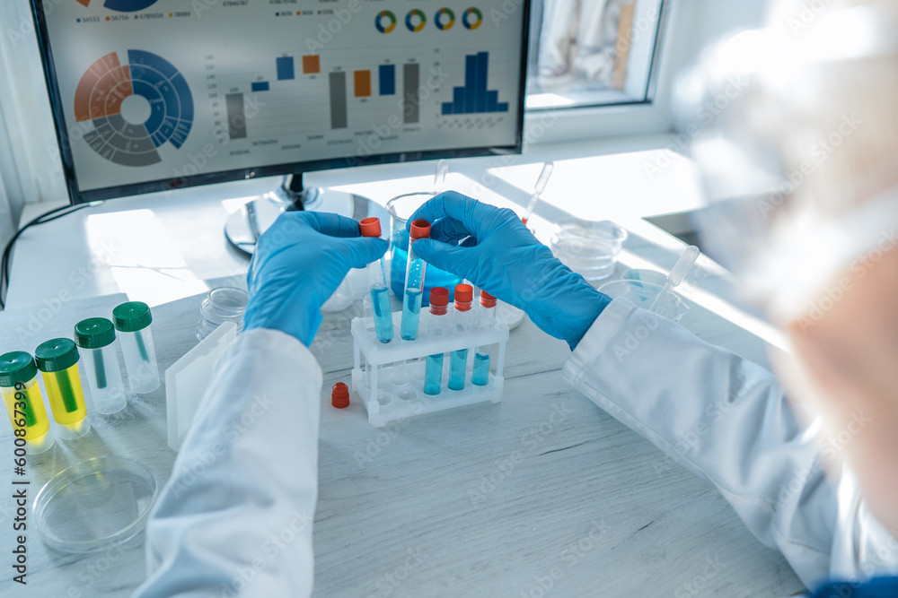 A medical worker performing tests on instruments in a chemical ...