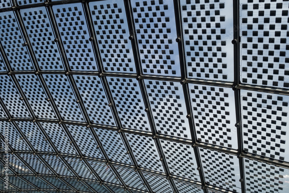 Translucent photovoltaic modules on transparent roof. Modern ...