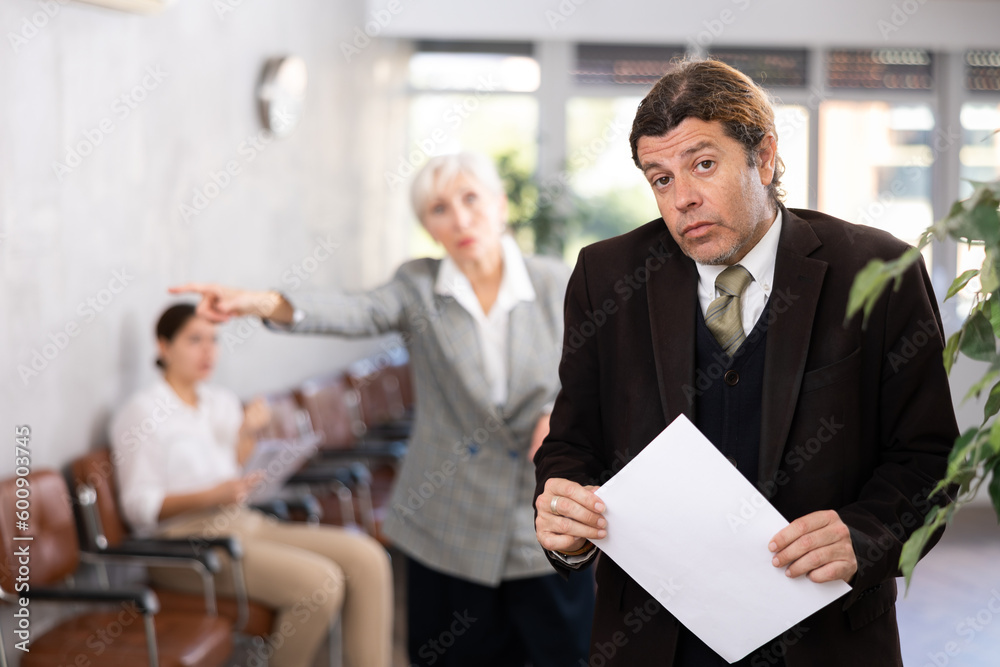 Angry coworker communicating with male inexperienced upset colleague in ...