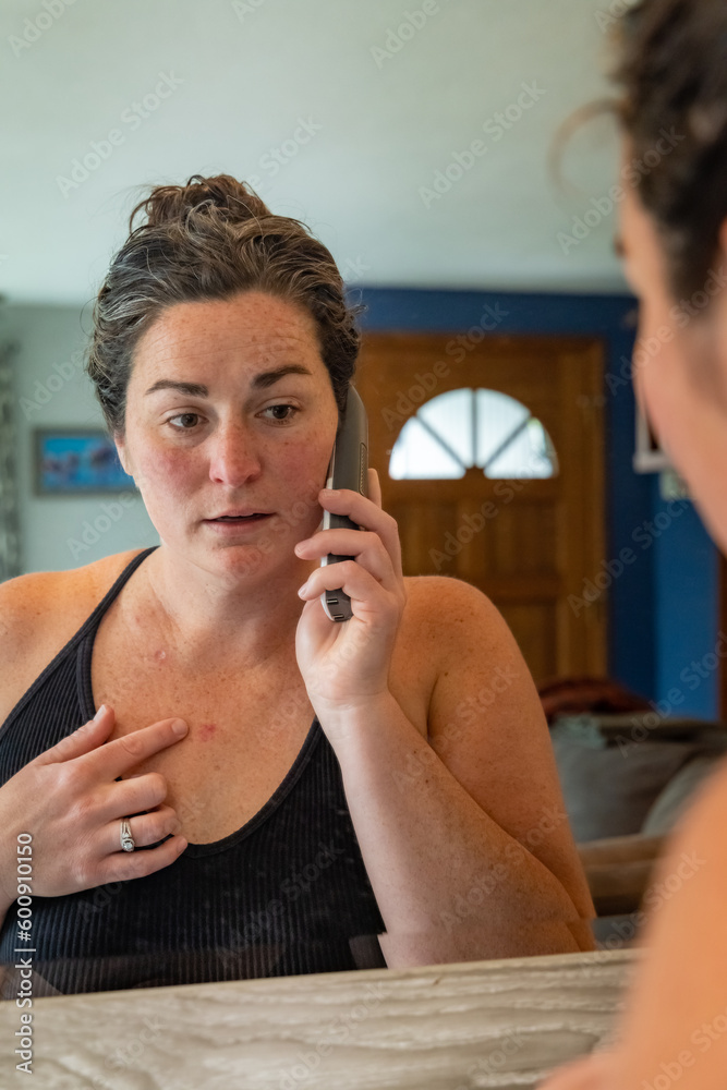 Young female mirror reflection calls doctor about skin cancer basal ...