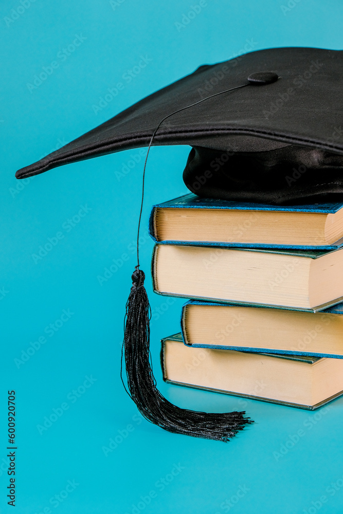 Education concept.Graduation Cap with a stack of books.Books with blue ...
