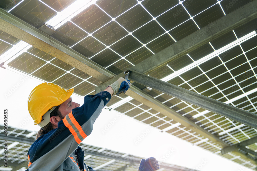 Factory engineer man checking and repairing solar panel construction ...