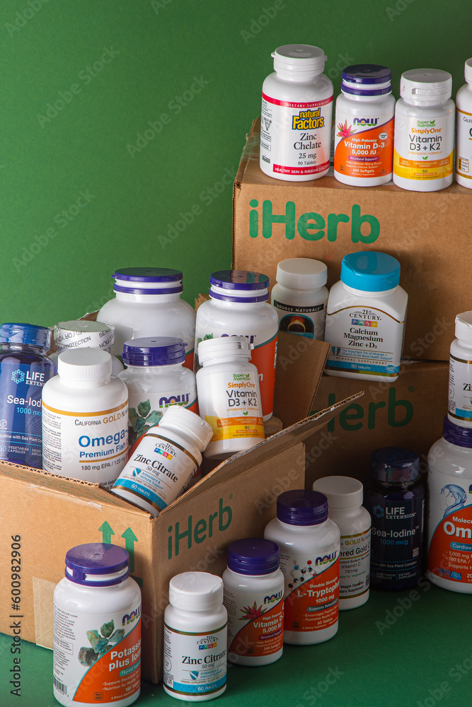 Vitamins, minerals and micronutrients from iHerb box. Lots of different jars. Biologically ...