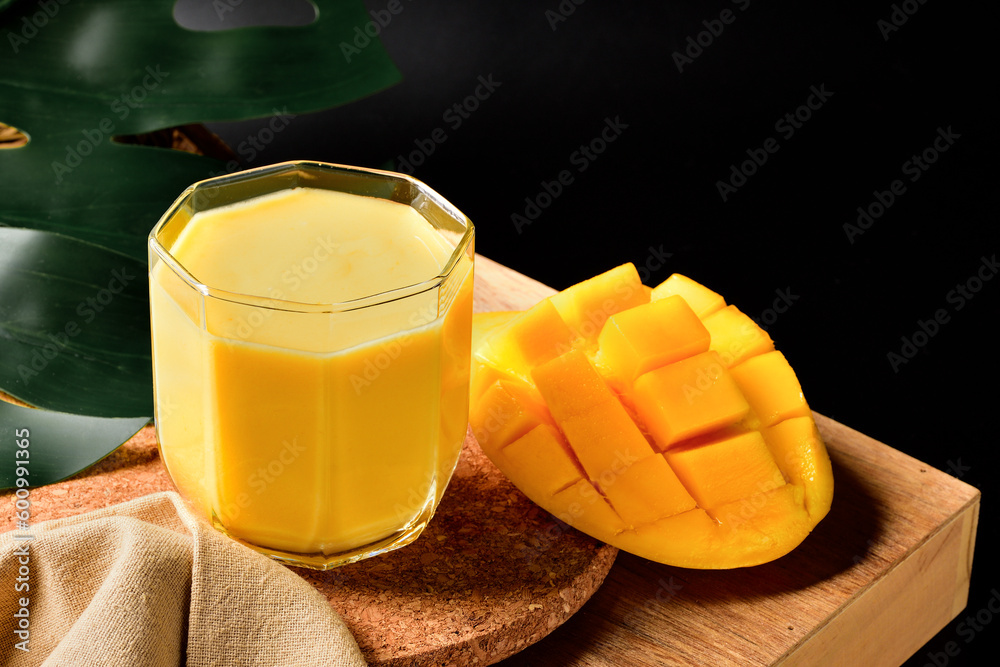 glass of mango smoothie.Thai Mango Smoothie on the wooden table.Food ...