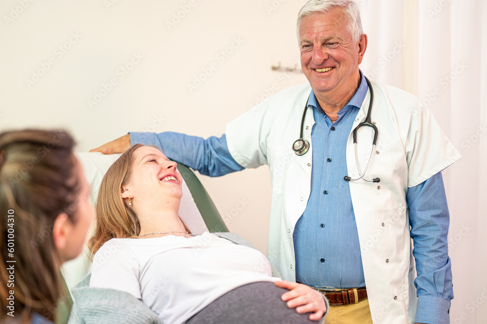 Doctor who visits a patient and reassures of the regular course of ...