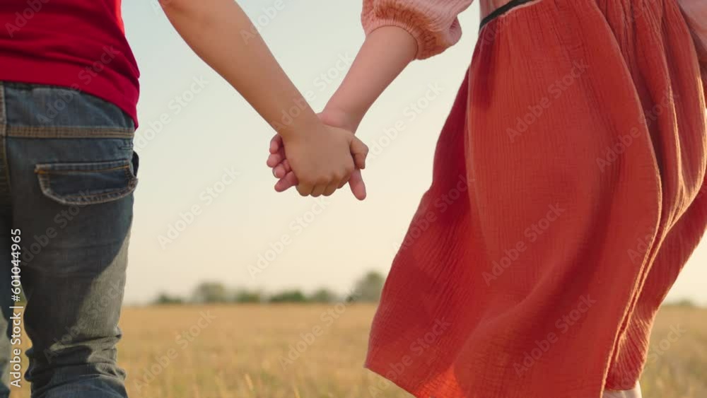 Children walking together in park hand in hand, nature. Concept of ...