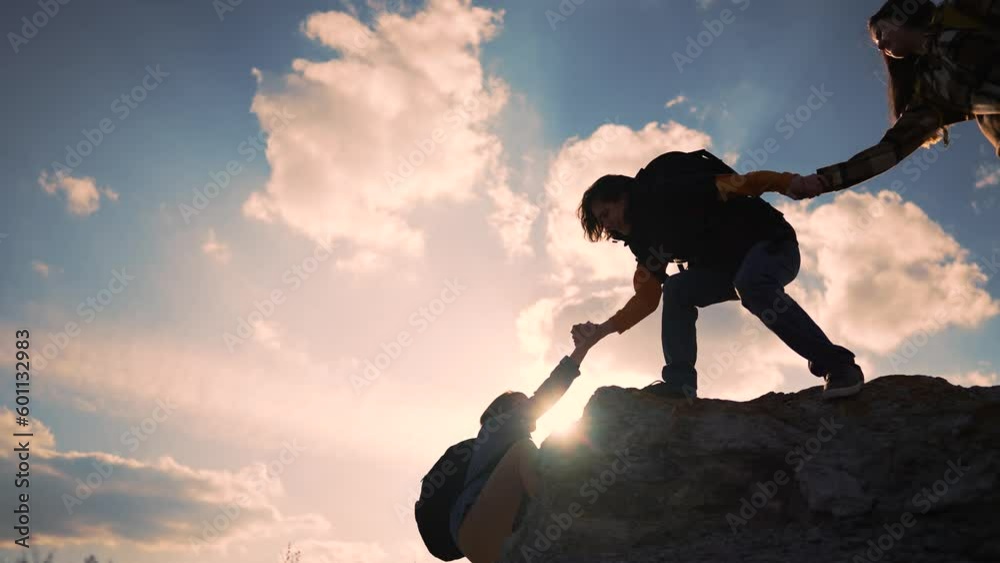Climbers team up to conquer the mountain.Helping hand in teamwork is ...