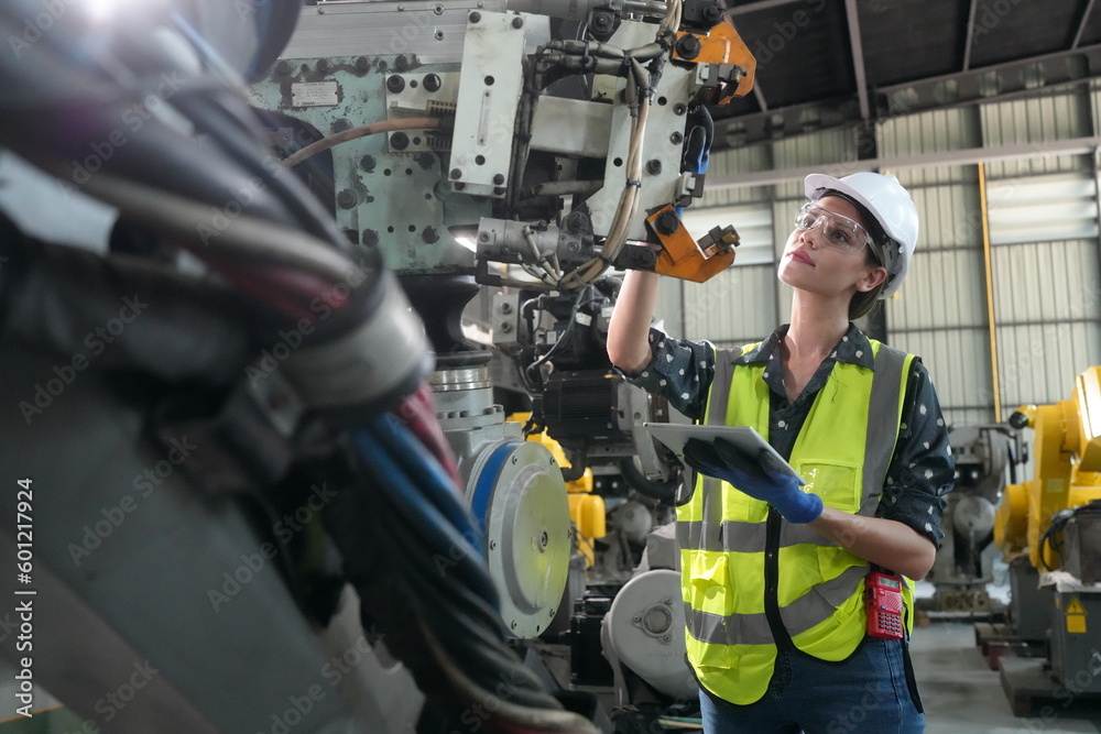 Mechanical engineers with robotic welder. Robotic Arm engineer check on ...