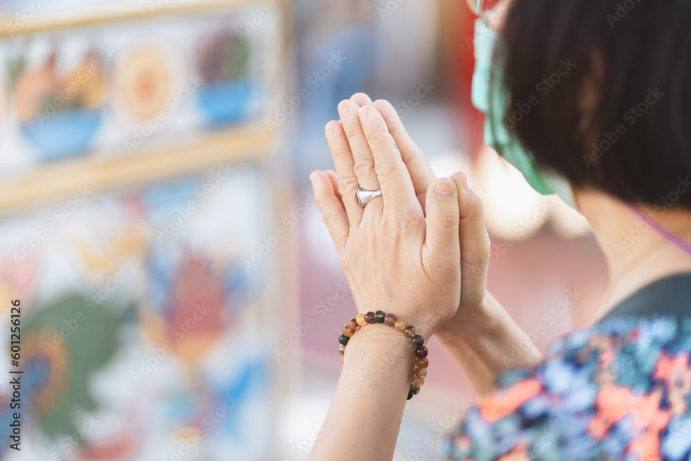 Asian adult woman join hands, press hands together at chest in sign for ...