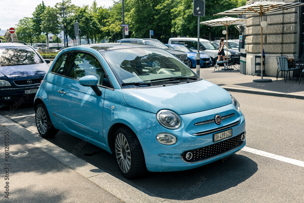 A blue tiny Fiat 500 parked by street in Zurich city. Fiat 500 is a ...