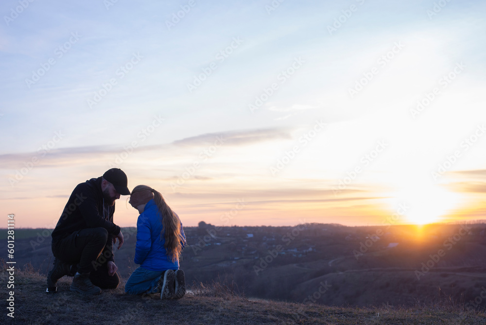 Man on his knees praying. Dad and daughter. Father's Day On the ...