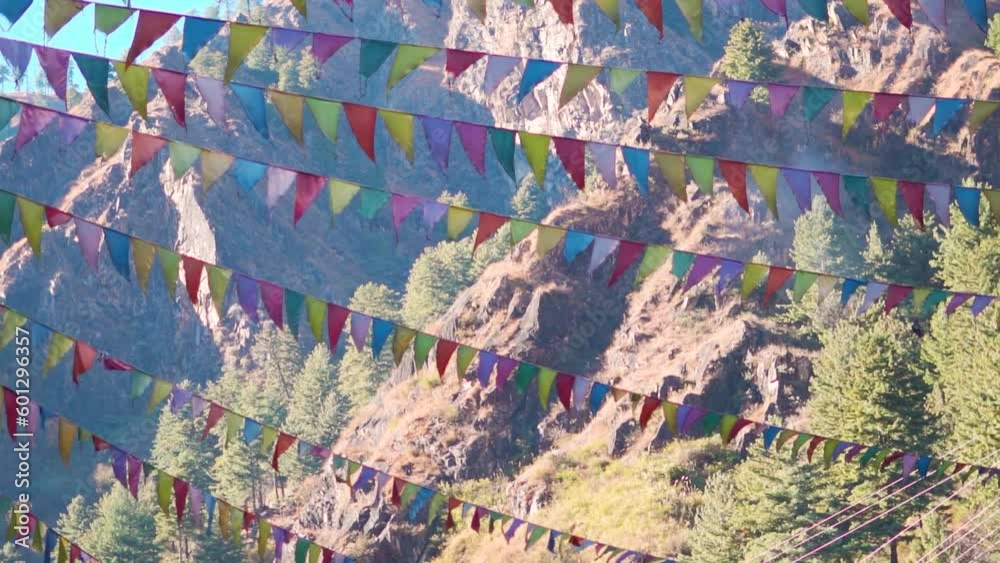 Prayer flags in front of the mountains at Gurudwara Sahib Manikaran at ...
