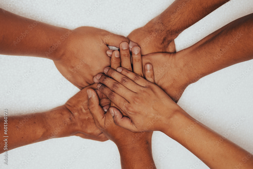 Top view of diverse people putting their hands together on white ...