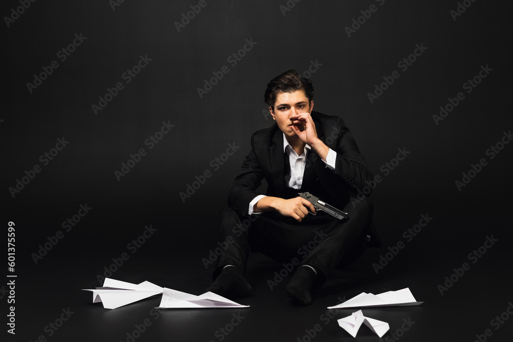 Sitting on the floor Young mafia member with a slicked back hair, in ...