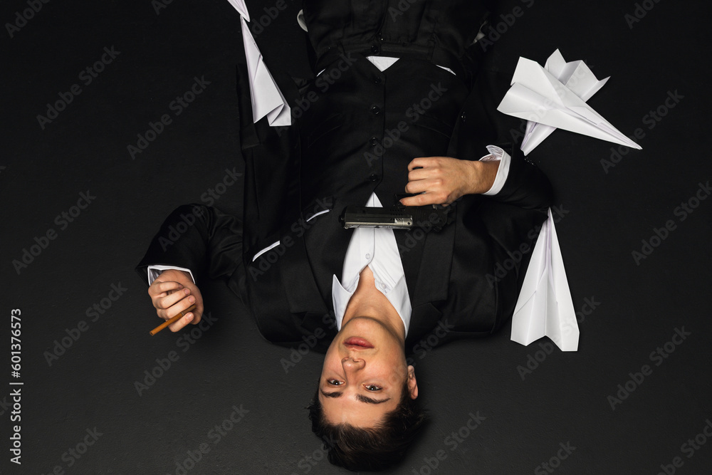 Lying on a floor Young mafia member with a slicked back hair, dressed ...