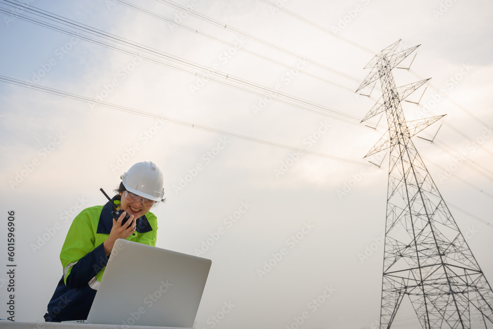 A picture of an woman electrical engineer Use a laptop computer to ...