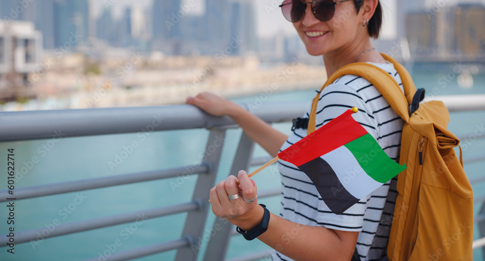 asian happy traveler woman with hat and yellow backpack with the flag ...