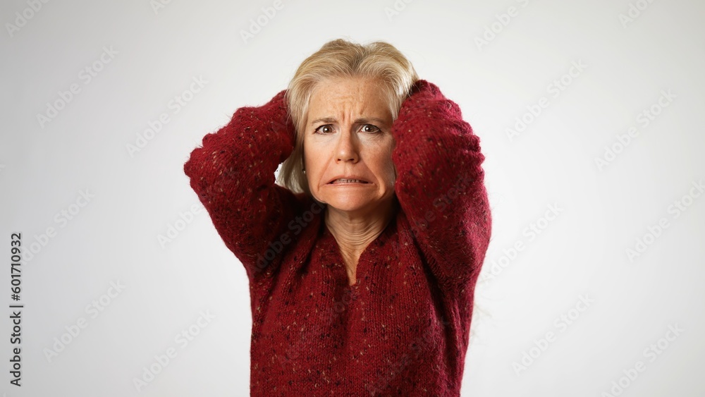 Portrait of pretty blond frustrated shaking head and pulling at hair ...