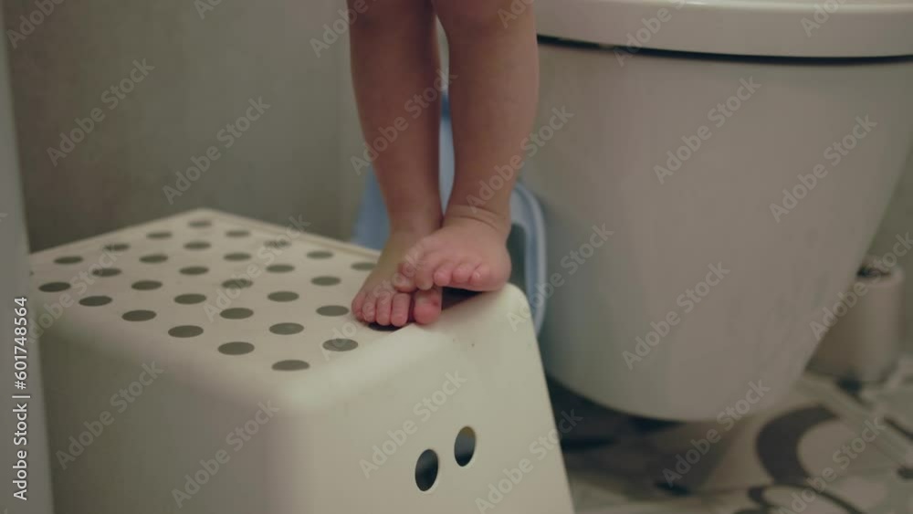 barefoot child legs standing step stool footstool in bathroom. tiptoes ...