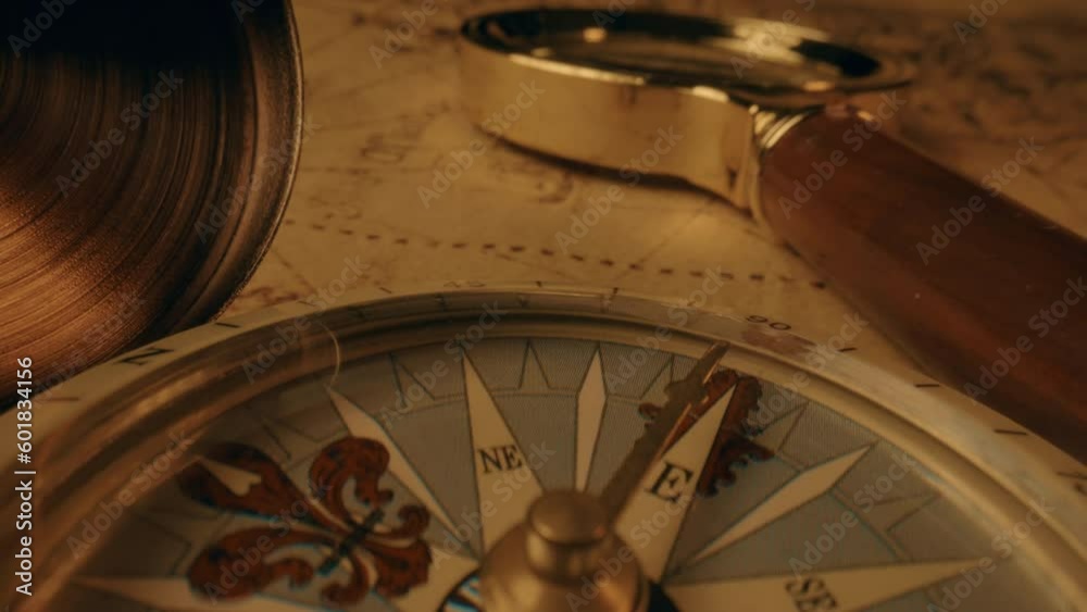 Compass and magnifier on a old vintage world map with countries and ...