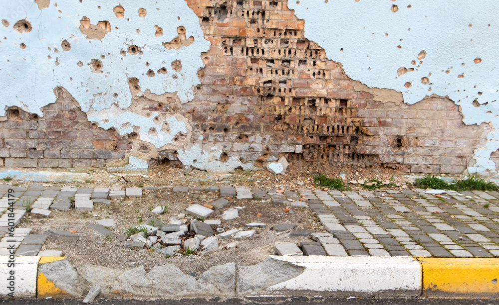 War in Ukraine. Funnel from the explosion in the asphalt. The trace ...