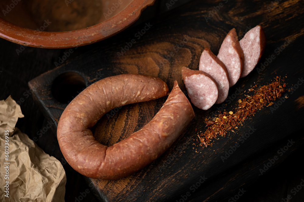 Half-smoked sausage ring. Sausage is cut into circles with spices on ...