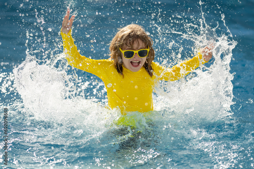 Kid splashing in summer water pool. Kid splash in swim pool. Excited ...