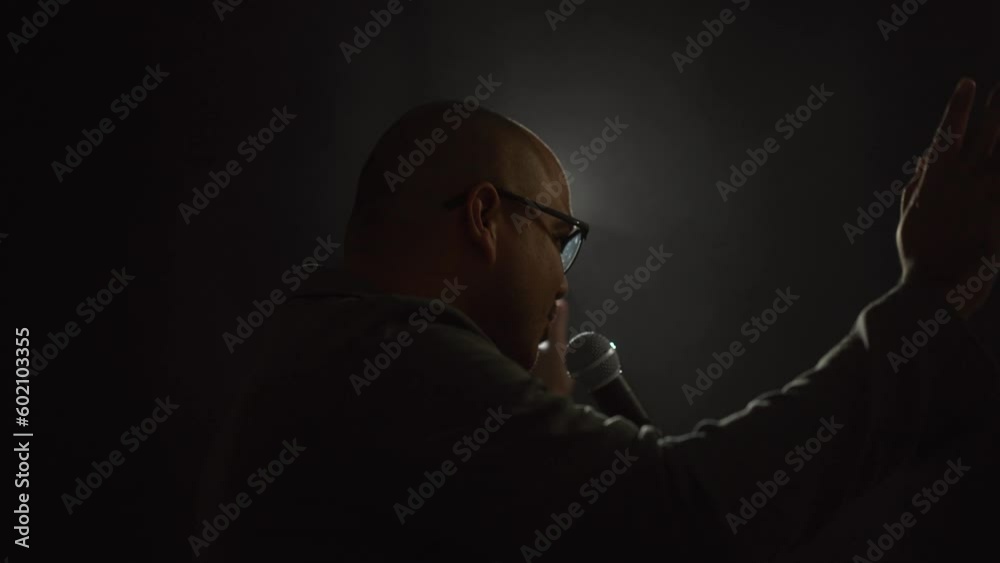 Confident successful speaker man talking and goodbye on stage with ...