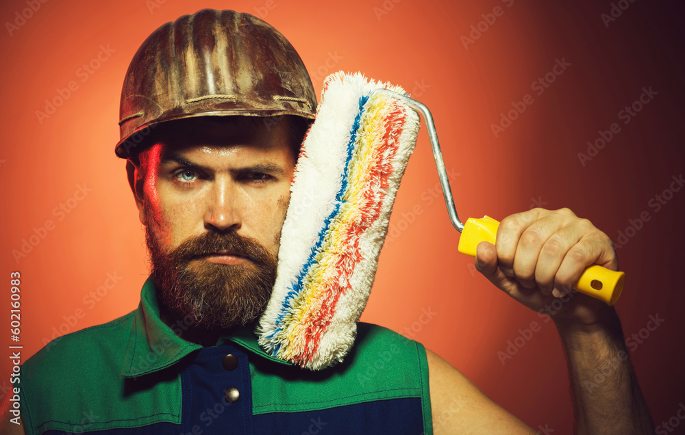 Professional painter man in helmet with paint roller. Bearded painter ...