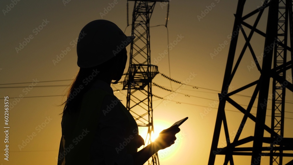 Electrical Engineer. engineer work tablet sunset. towers electricity ...