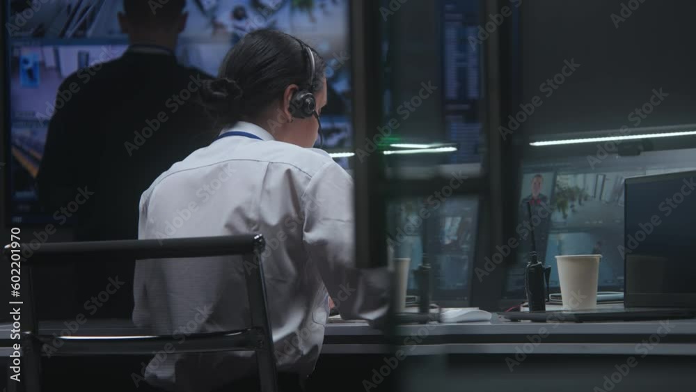 Female security officer works on computer in police monitoring center ...