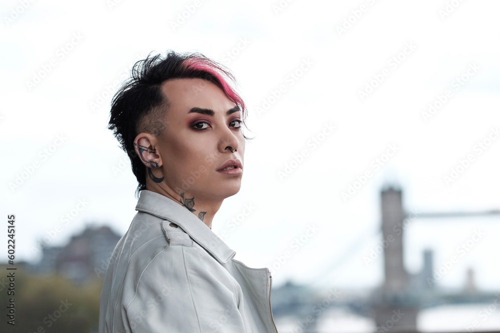 Androgynous male model looking at camera with Tower Bridge background ...