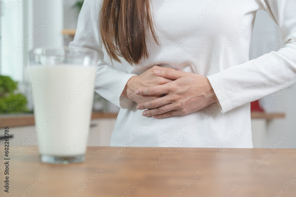 lactose intolerance concept. Woman having a stomach ache from lactose ...