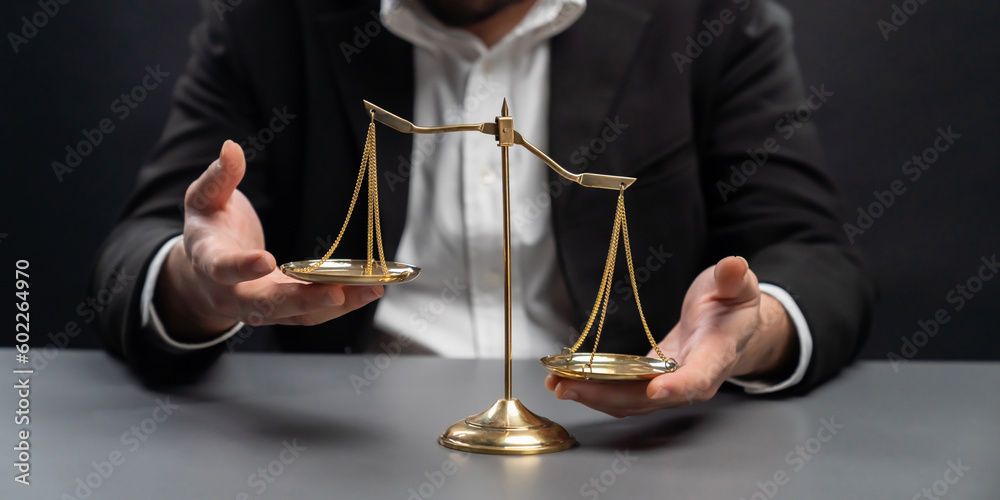Lawyer or judge in formal black suit hold unbalanced scale with ...
