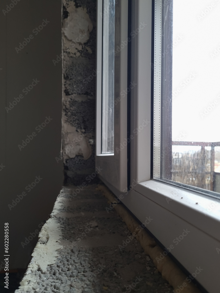 Old mounting foam between a pvc window and a brick wall. Dismantling of ...