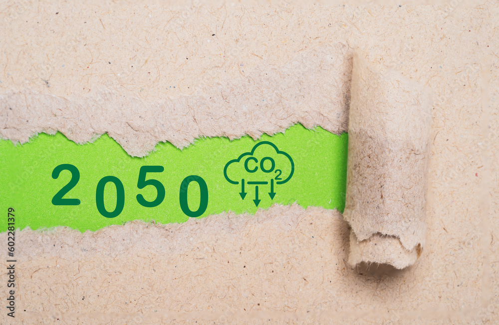 Foto de CO2 reducing icon with 2050 on green torn paper for decrease CO2 , carbon footprint and ...