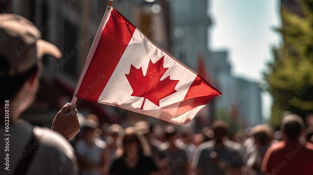 hand waving a Canadian flag during a Canada Day parade Stock ...